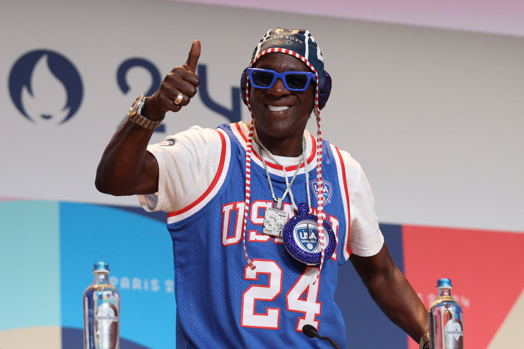 Flavor Flav Unveils Bronze Clock Necklace For Jordan Chiles - WBLS